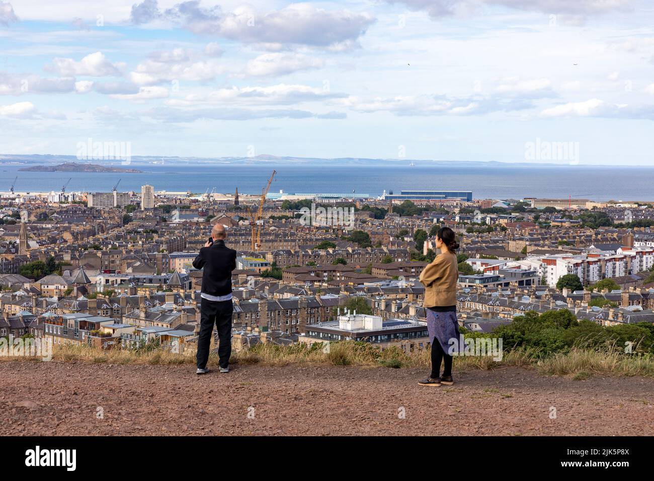 Calton Hill Edinburgh, man and woman take in the sights of Edinburgh ...