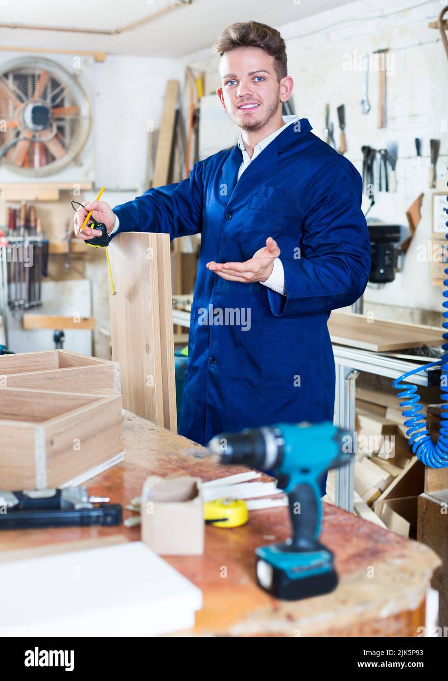 Male worker checking measurements Stock Photo - Alamy