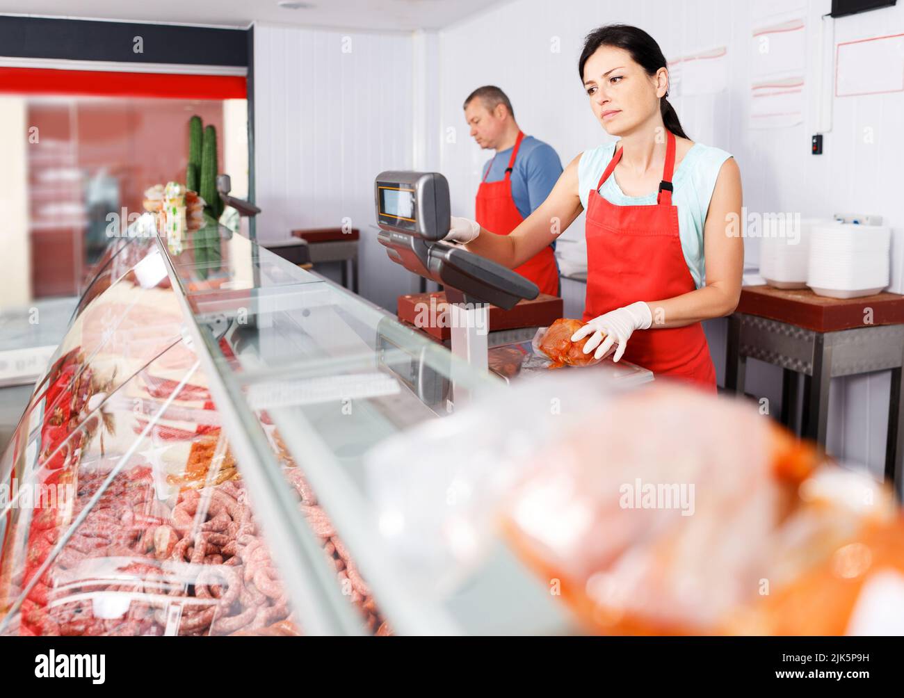 woman seller working at meat market Stock Photo - Alamy