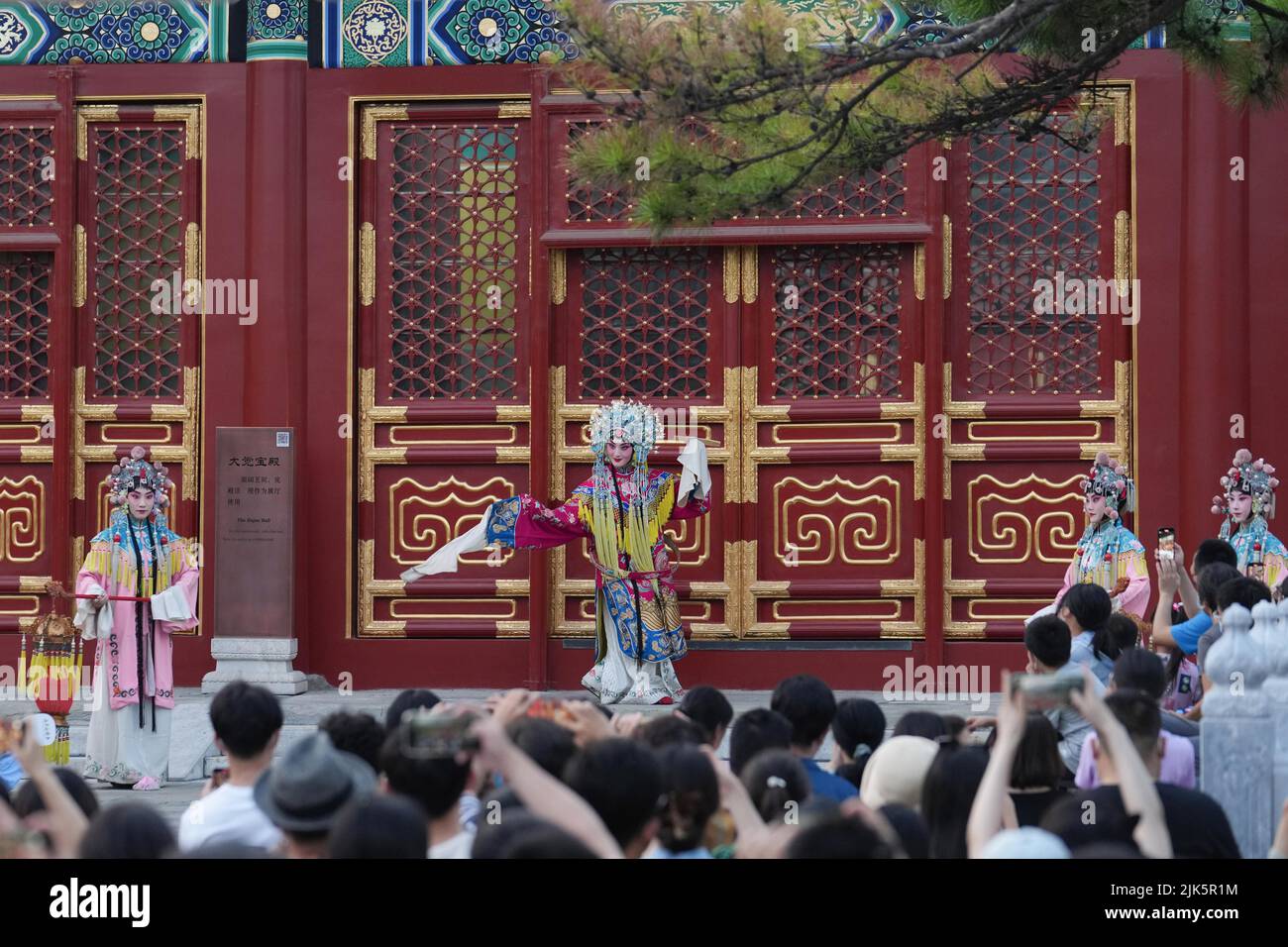 Beijing, China. 30th July, 2022. People watch a Peking opera ...