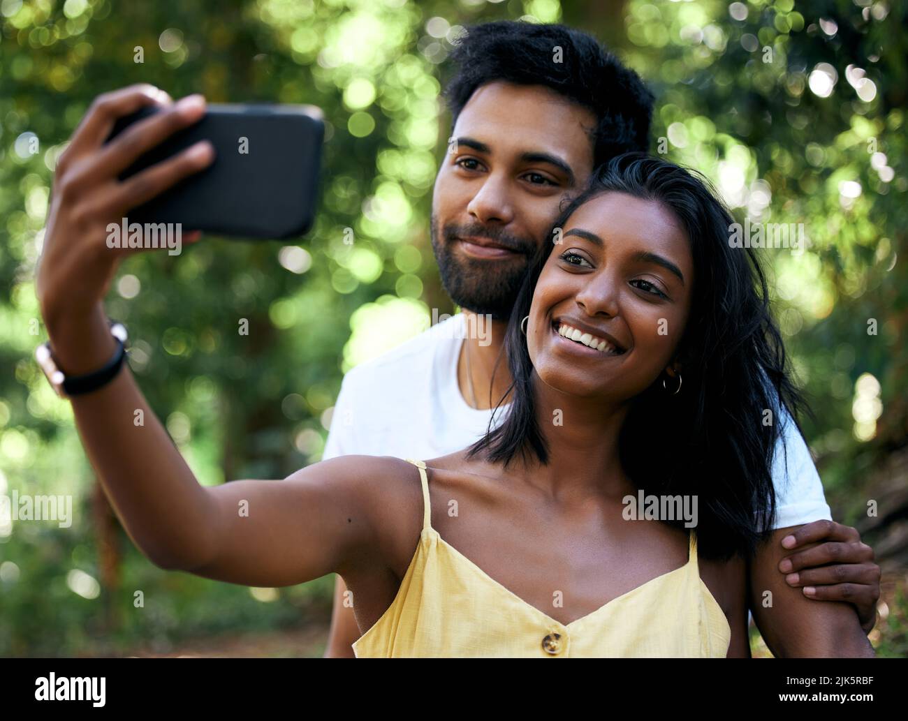 Its our first selfie together. a young couple taking a selfie while out ...