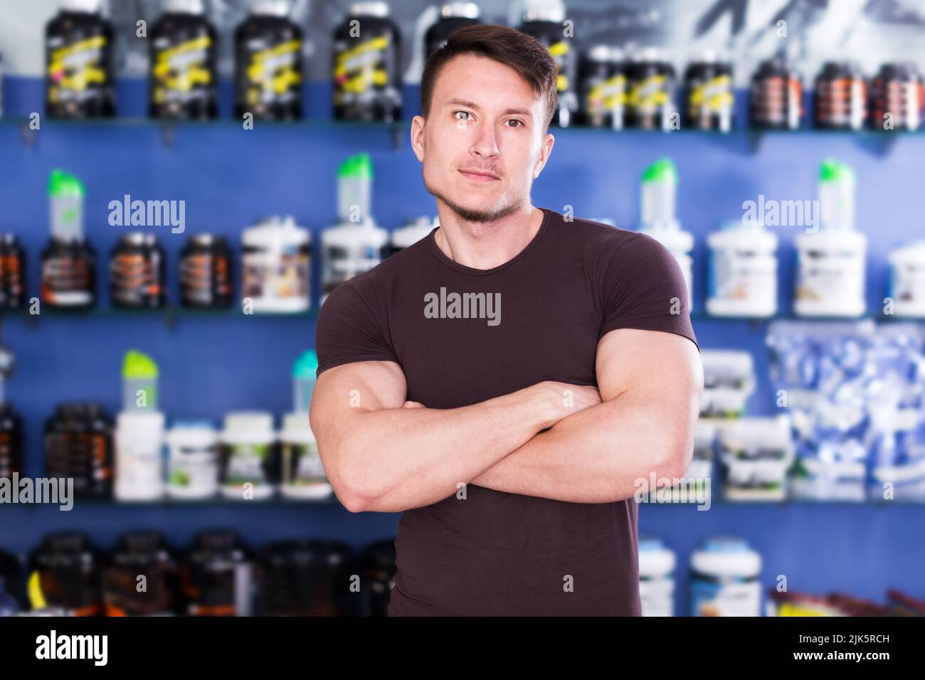 Athletic guy in sports nutrition shop Stock Photo - Alamy