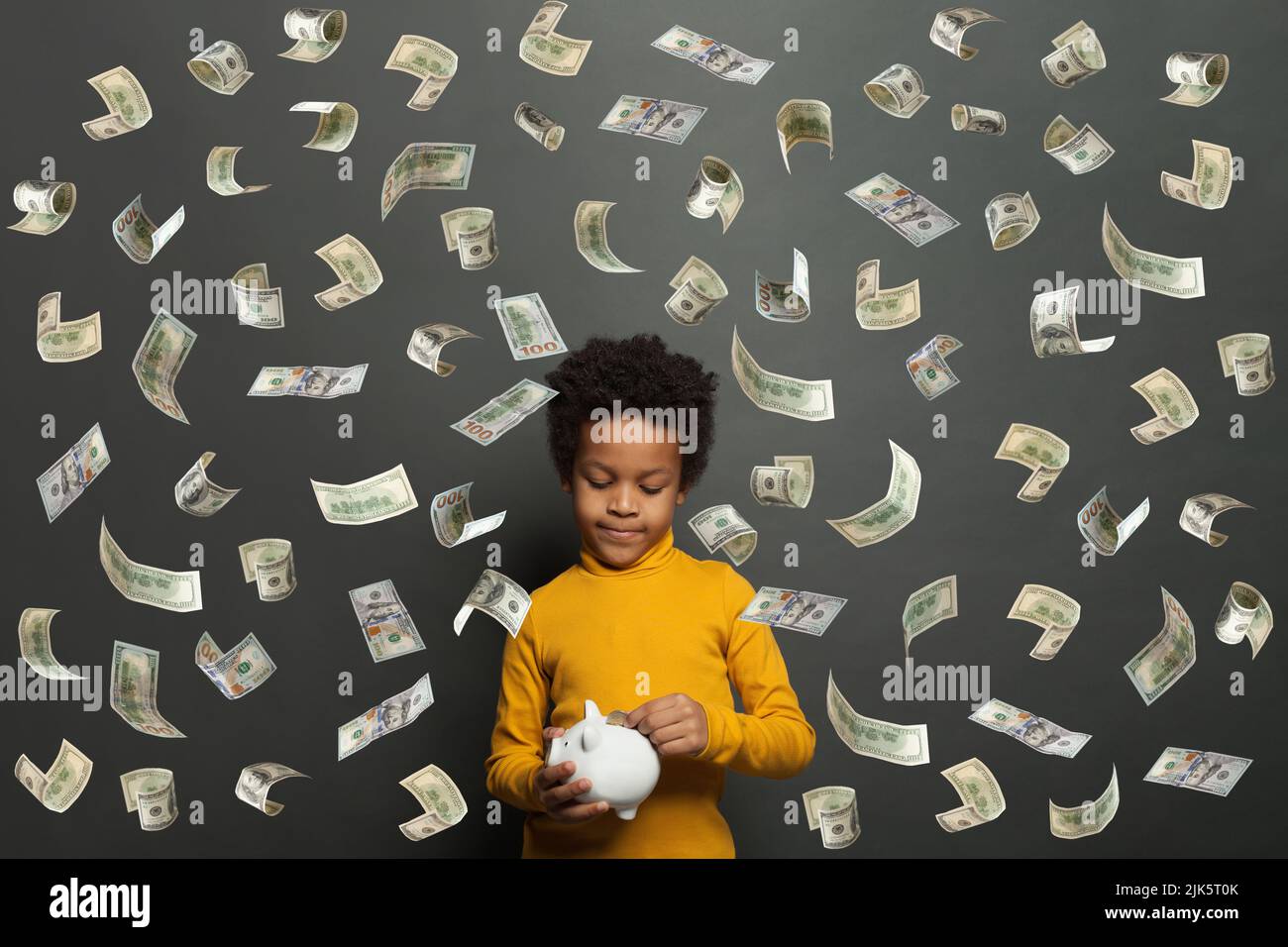 Serious smart little boy on falling us dollar money rain on black ...