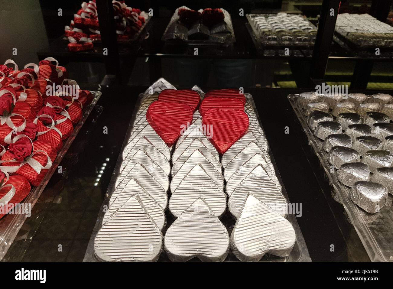 Assorted chocolate candies in red and silver papers Stock Photo - Alamy