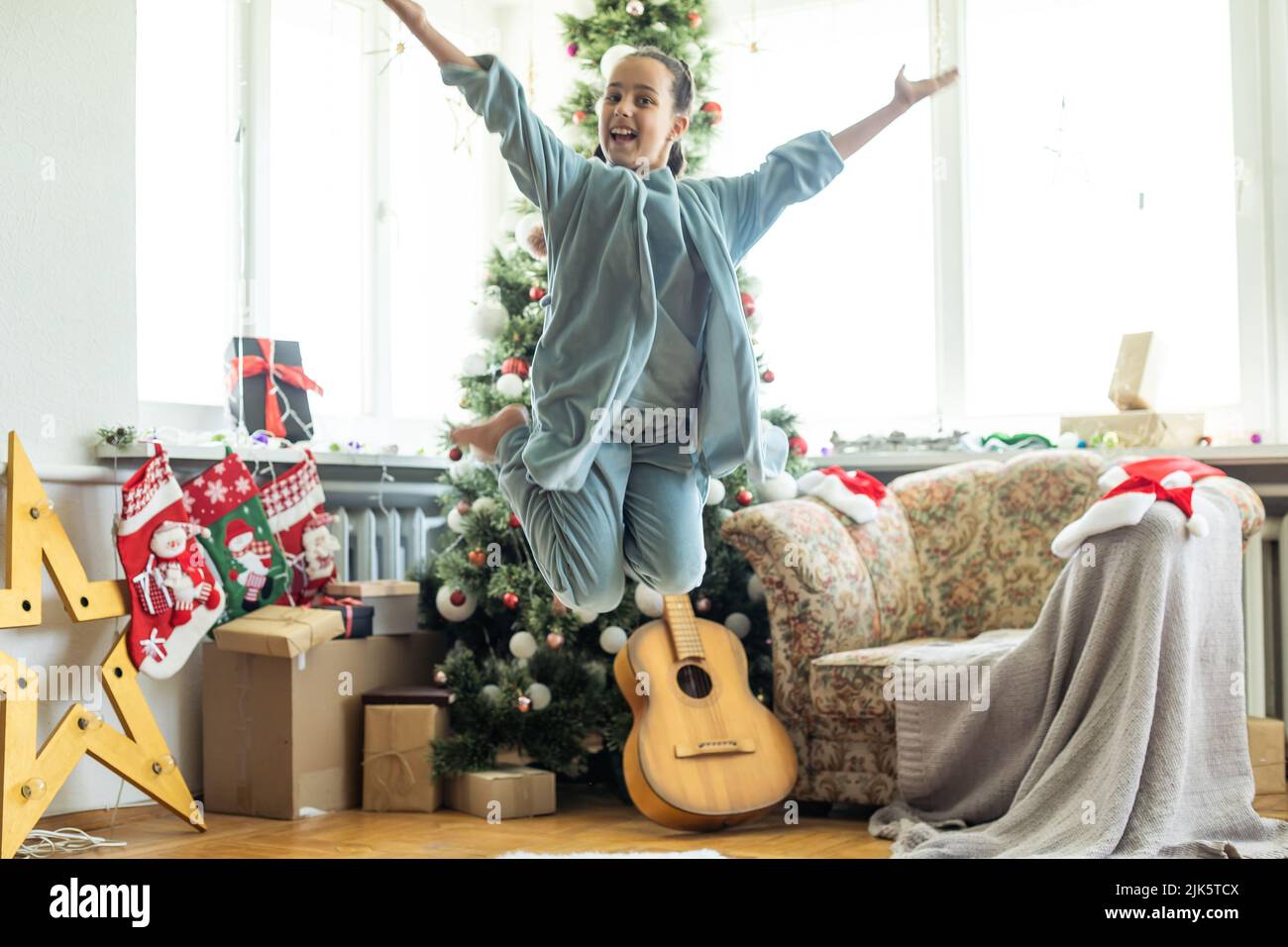 Merry Christmas and Happy Holidays. Cute little child girl is ...