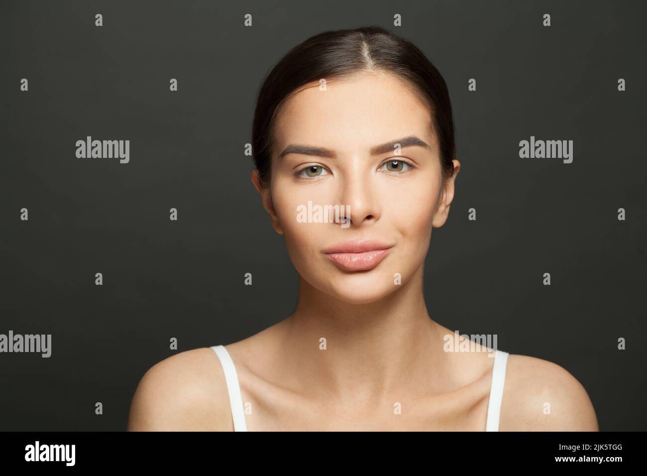 Beautiful female model brunette woman with healthy clean skin looking ...