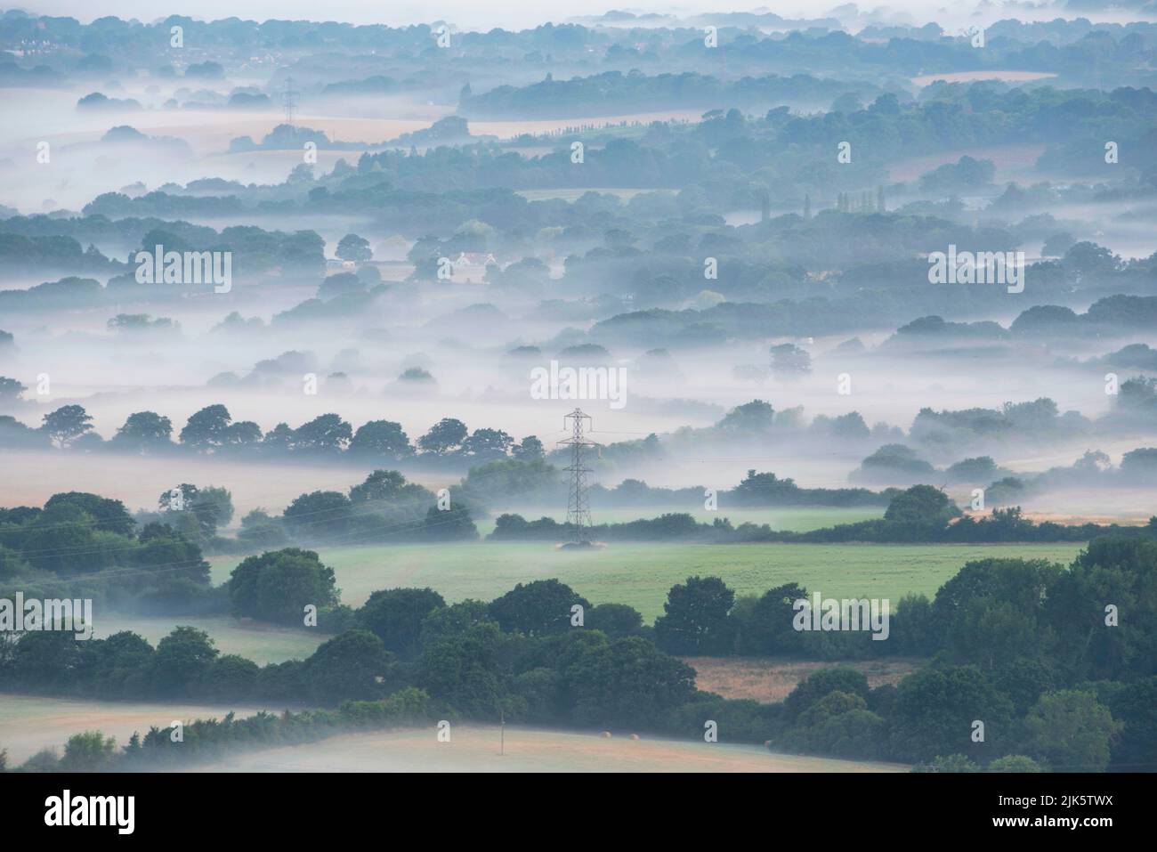 Stunning landscape image of layers of mist rolling over South Downs ...