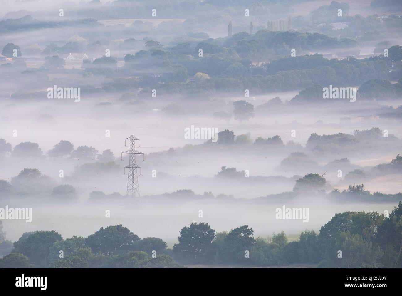 Stunning landscape image of layers of mist rolling over South Downs ...