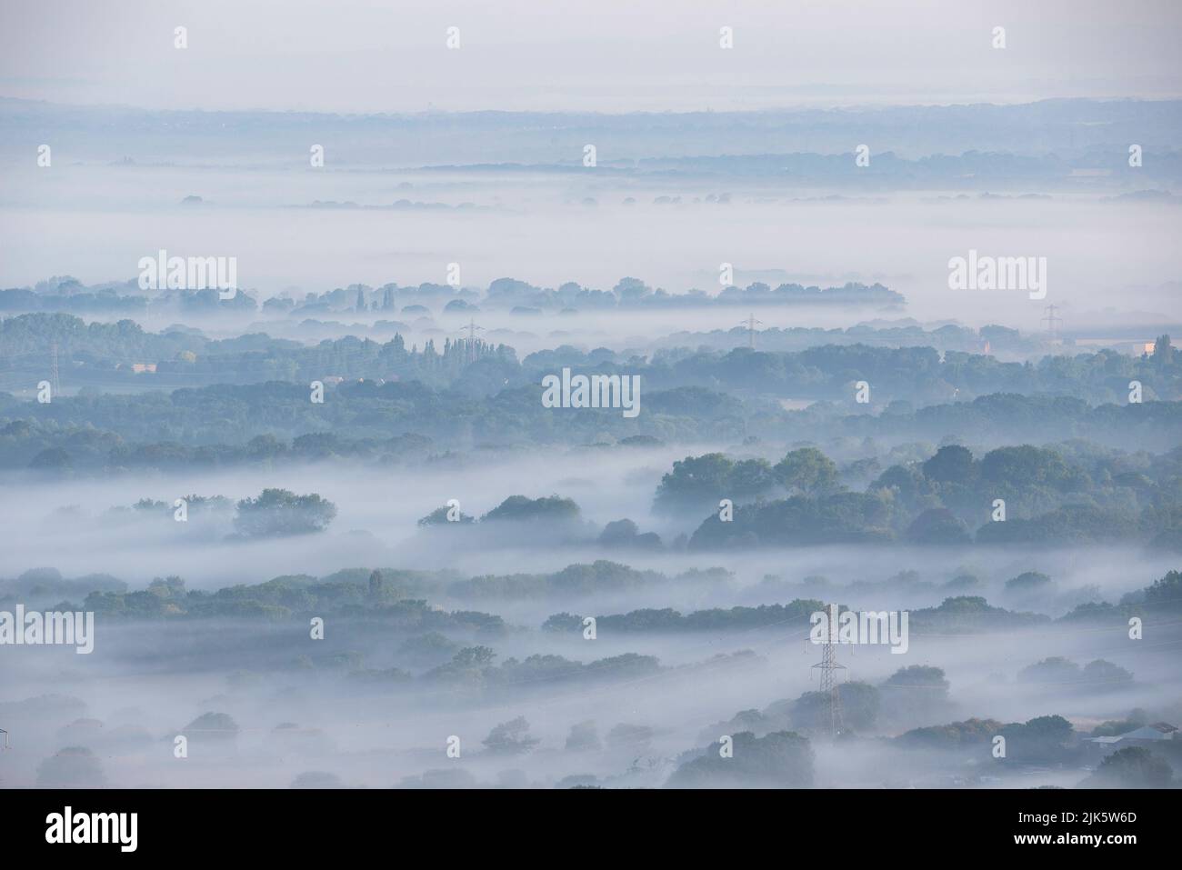 Stunning landscape image of layers of mist rolling over South Downs ...