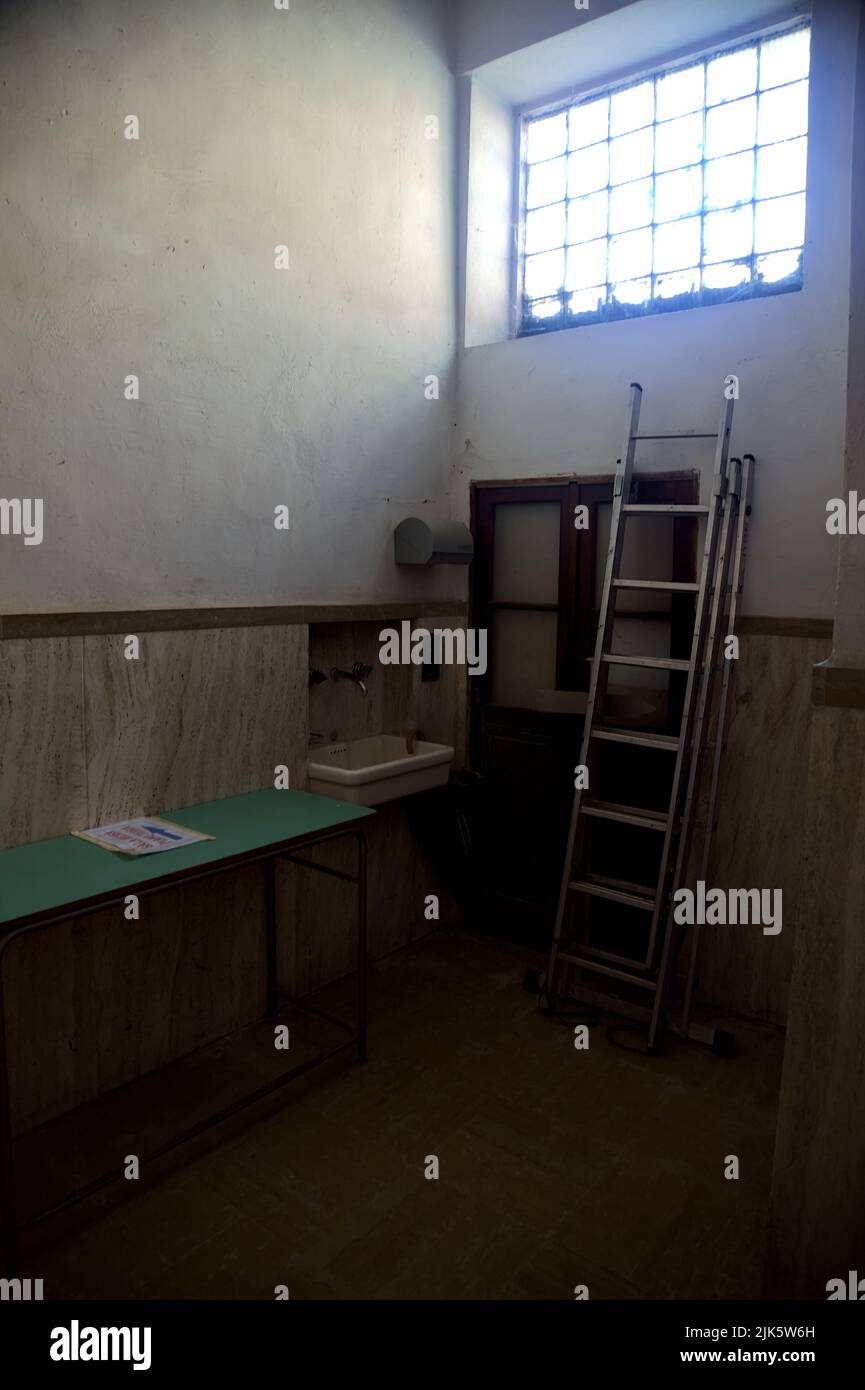 Utility room with a table and a ladder under a window Stock Photo - Alamy