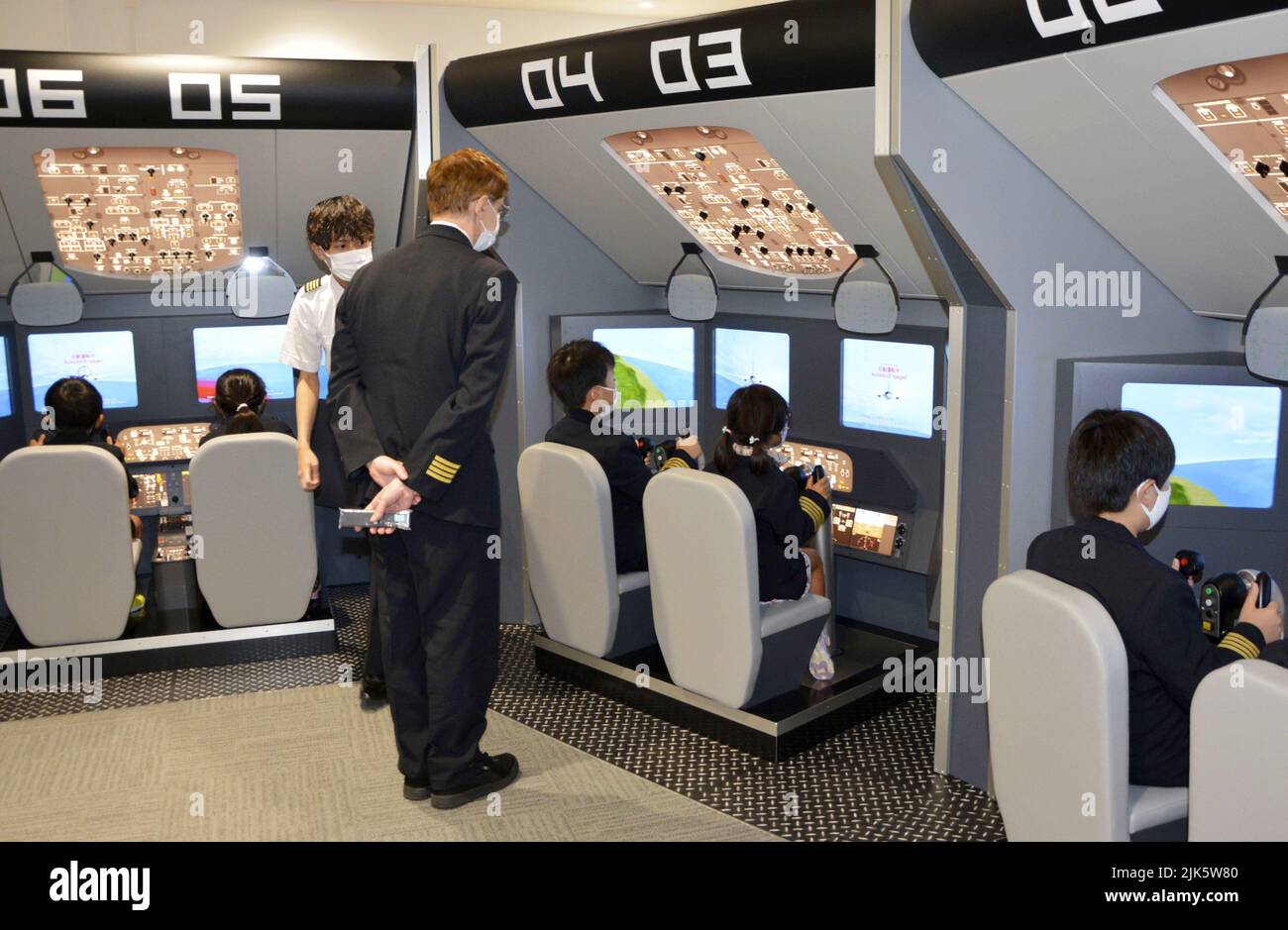 Children get the experience of operating an aircraft from a mock ...