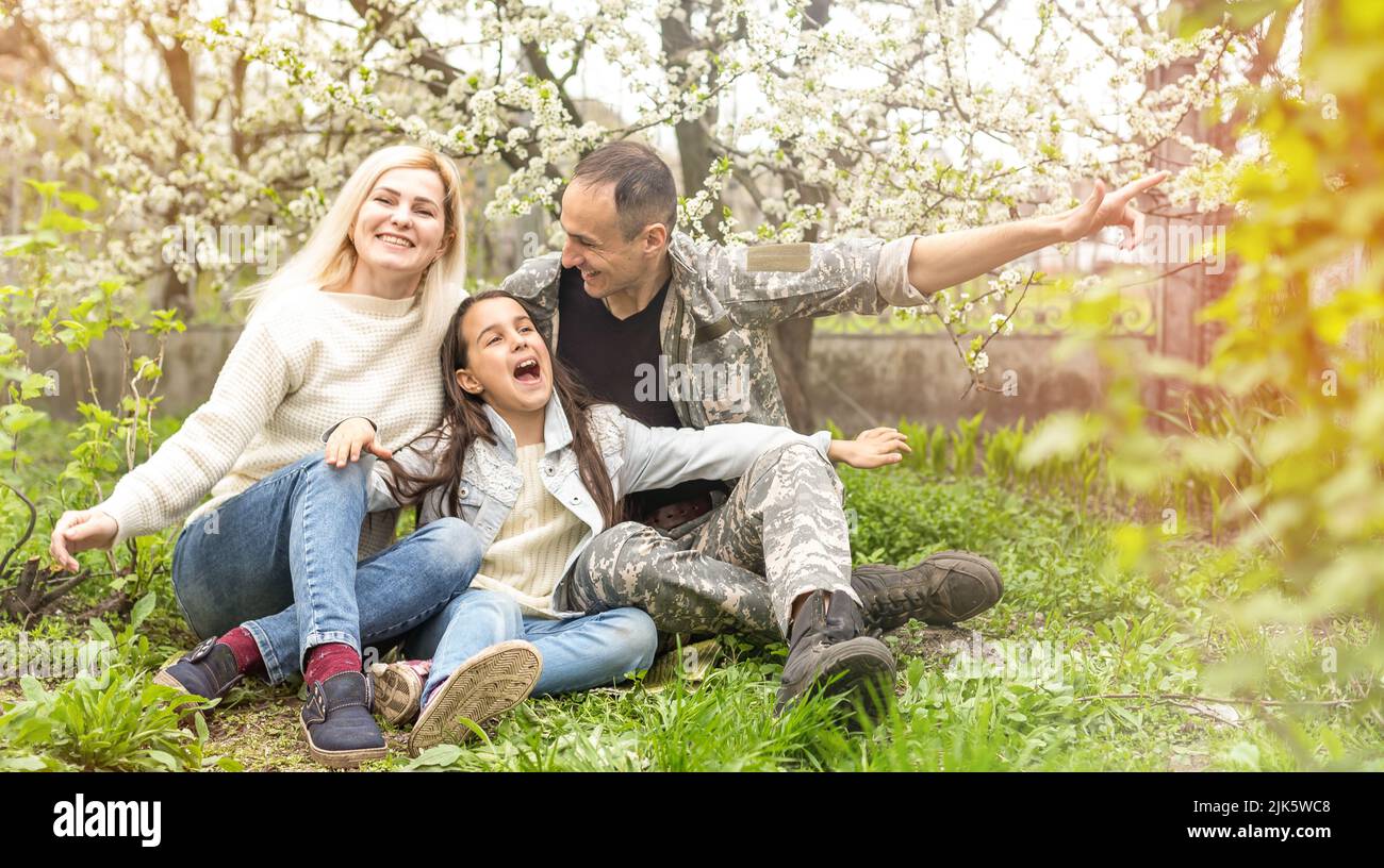 Soldier is meeting his family outdoors. Happy reunion of father and ...
