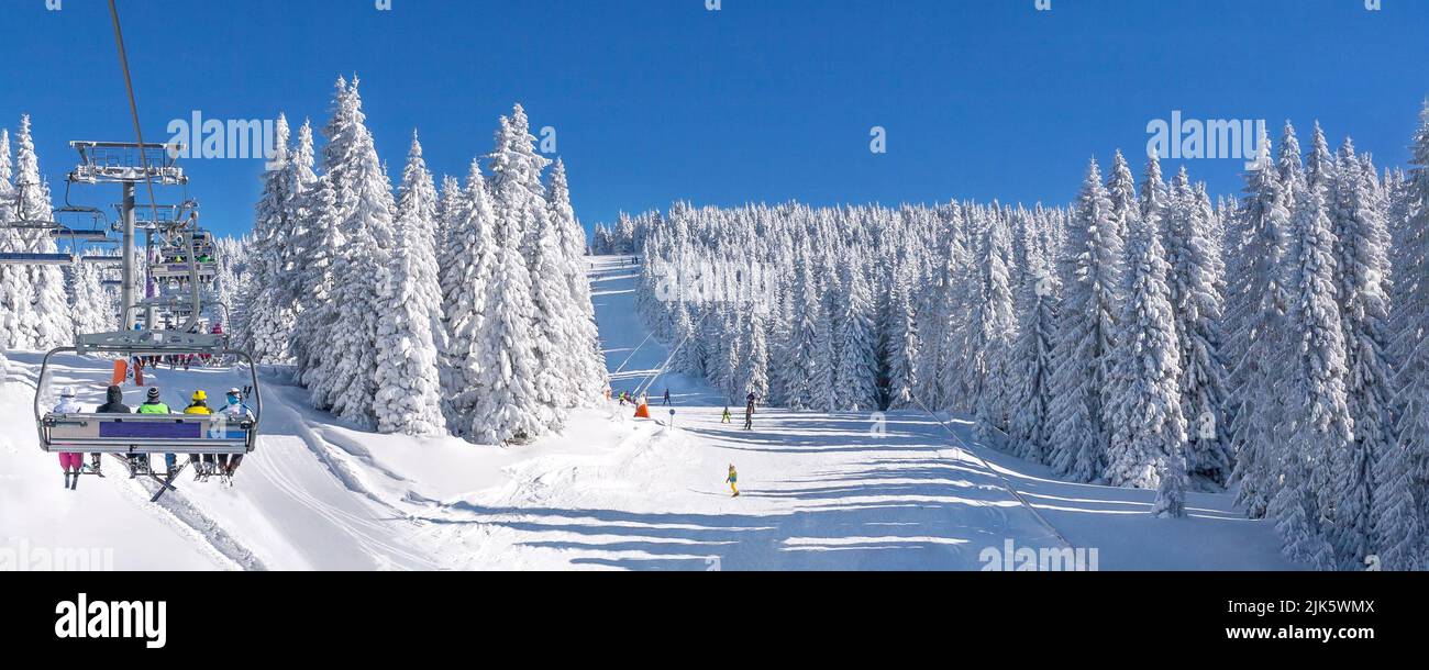Panorama of ski resort, slope, people on the ski lift, skiers on the ...