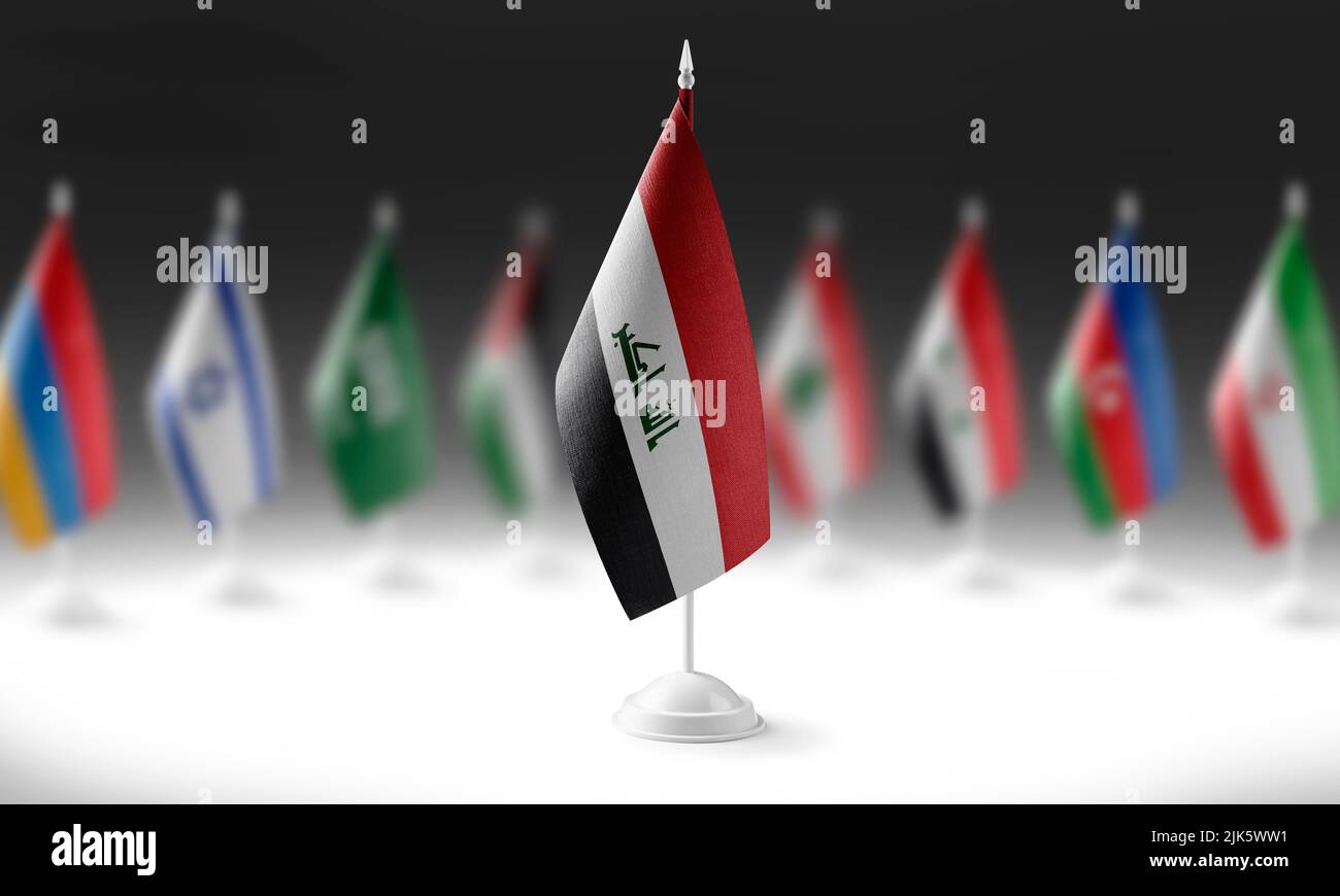 The national flag of the Iraq on the background of flags of other ...
