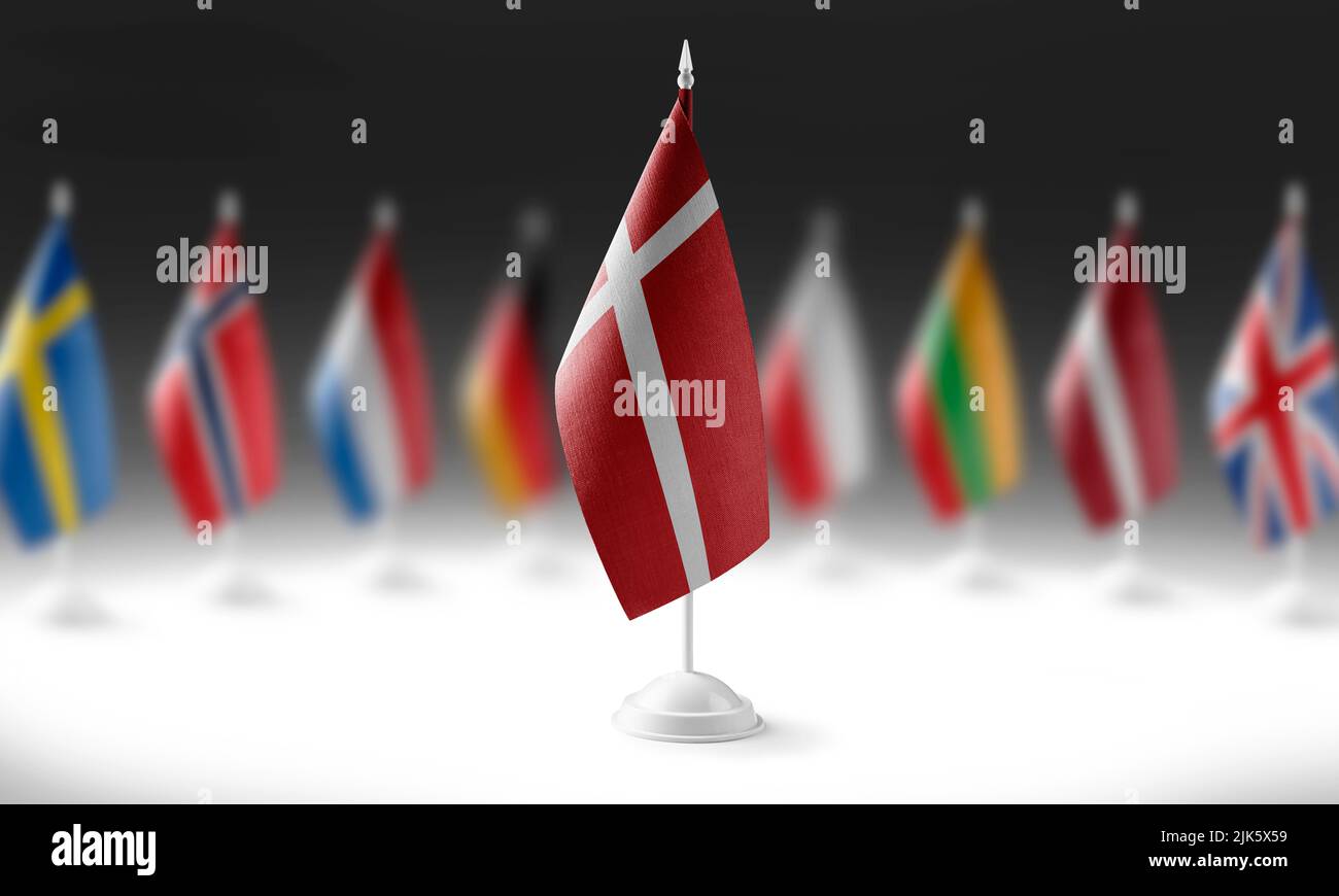 The national flag of the Denmark on the background of flags of other ...