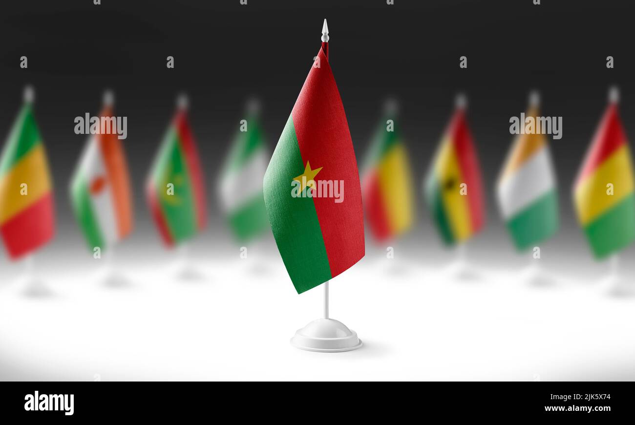 The national flag of the Burkina Faso on the background of flags of ...