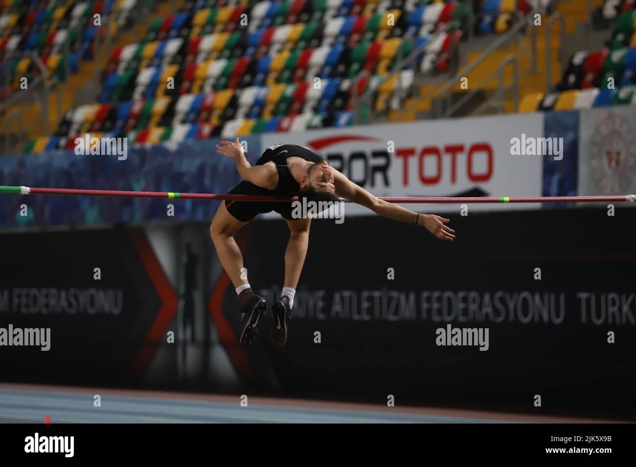 ISTANBUL, TURKEY - FEBRUARY 19, 2022: Undefined athlete high jumping ...