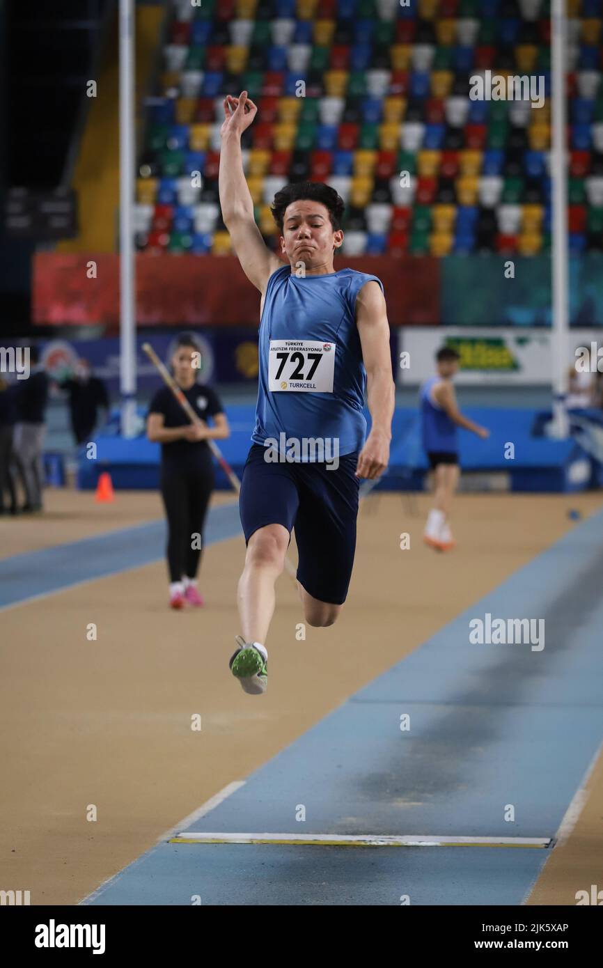 ISTANBUL, TURKEY - FEBRUARY 19, 2022: Undefined athlete triple jumping ...