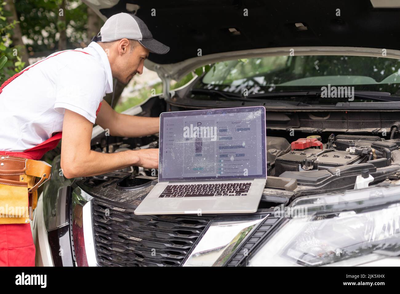 Mechanic repairing car using tools hi-res stock photography and images ...
