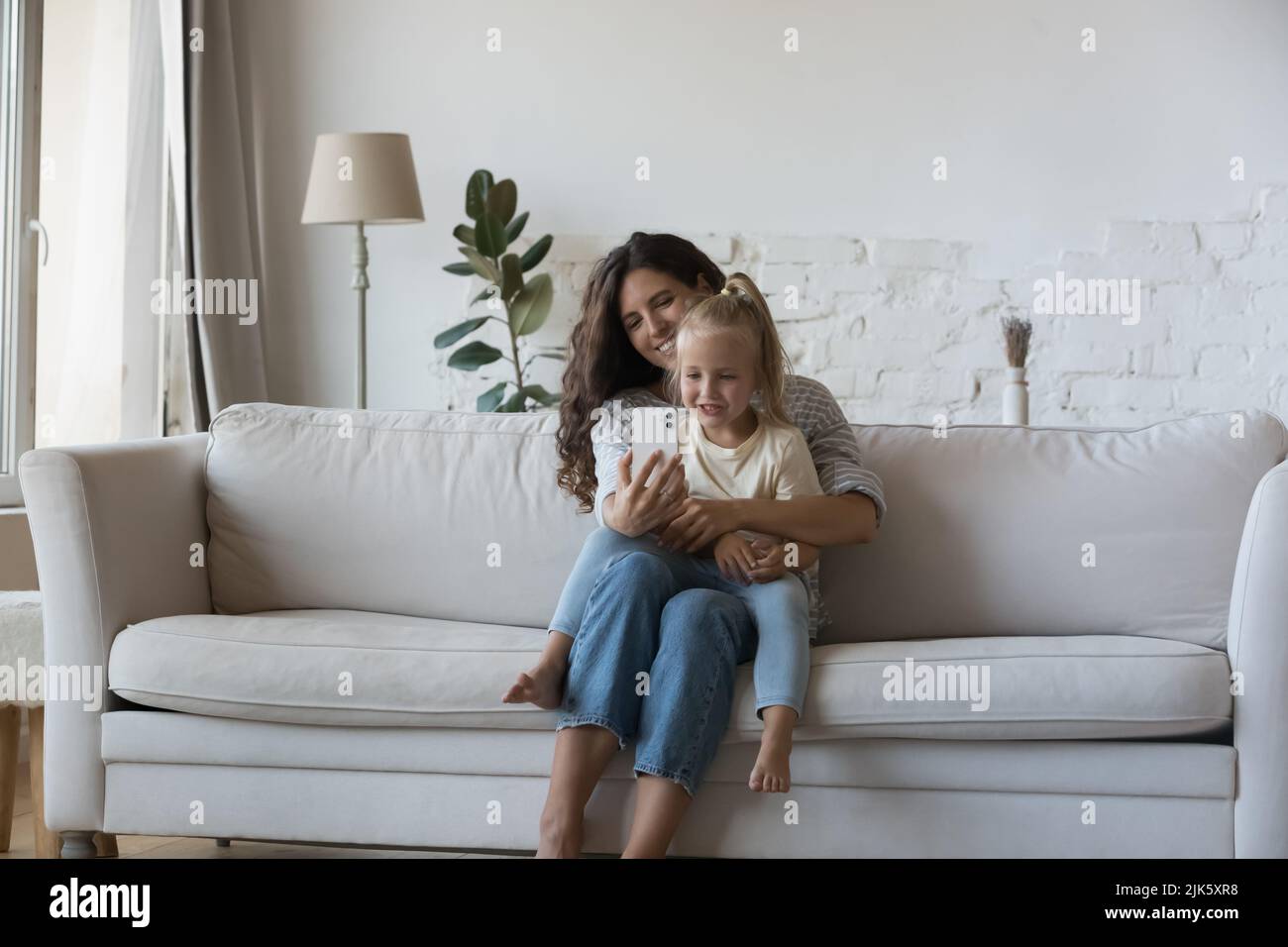 Cheerful mother and little kid talking on video call together Stock ...