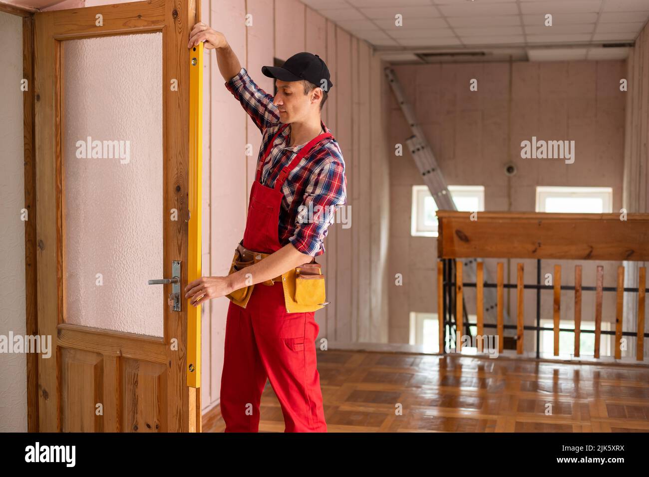 Carpenter worker installation process of measures cloth with ruler door ...