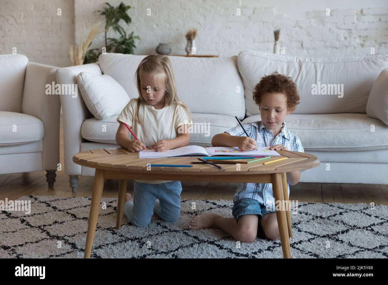 Brother and sister kids focused on creative learning activities Stock ...