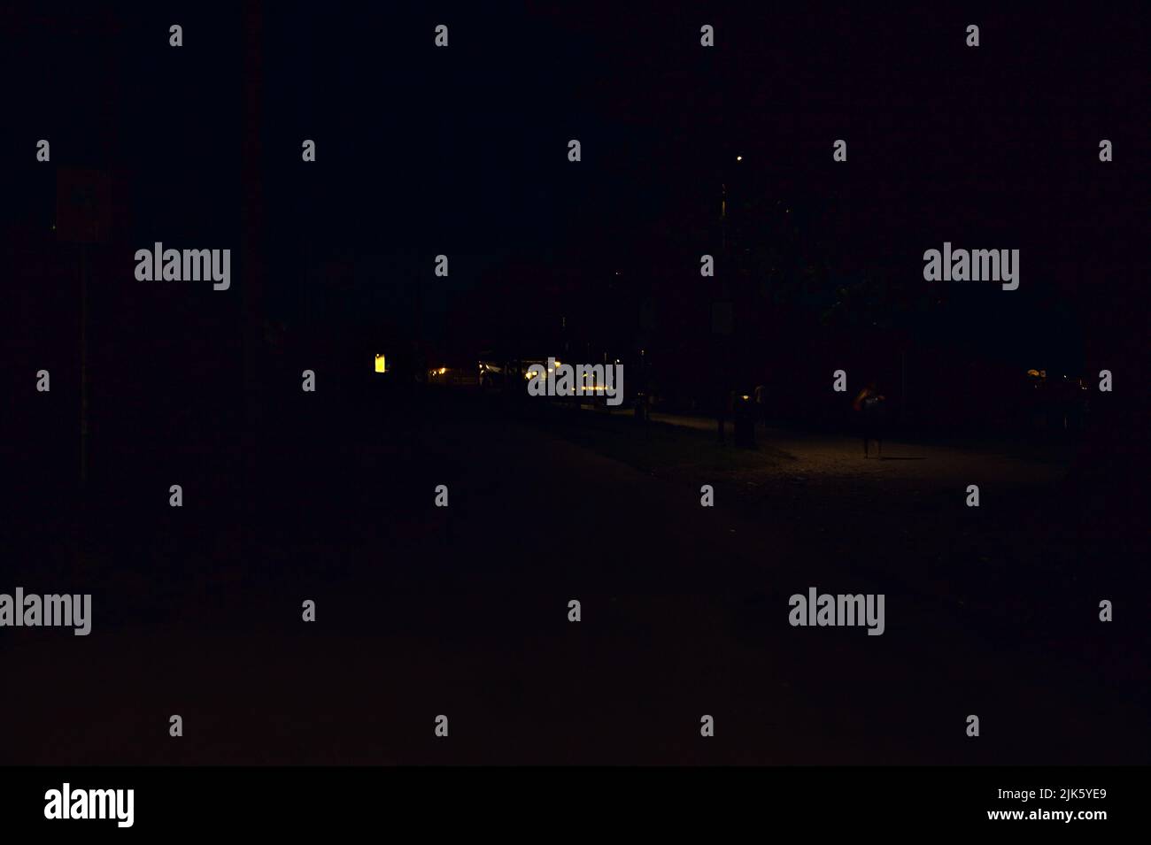 Path in a park at night with lights in the distance Stock Photo - Alamy