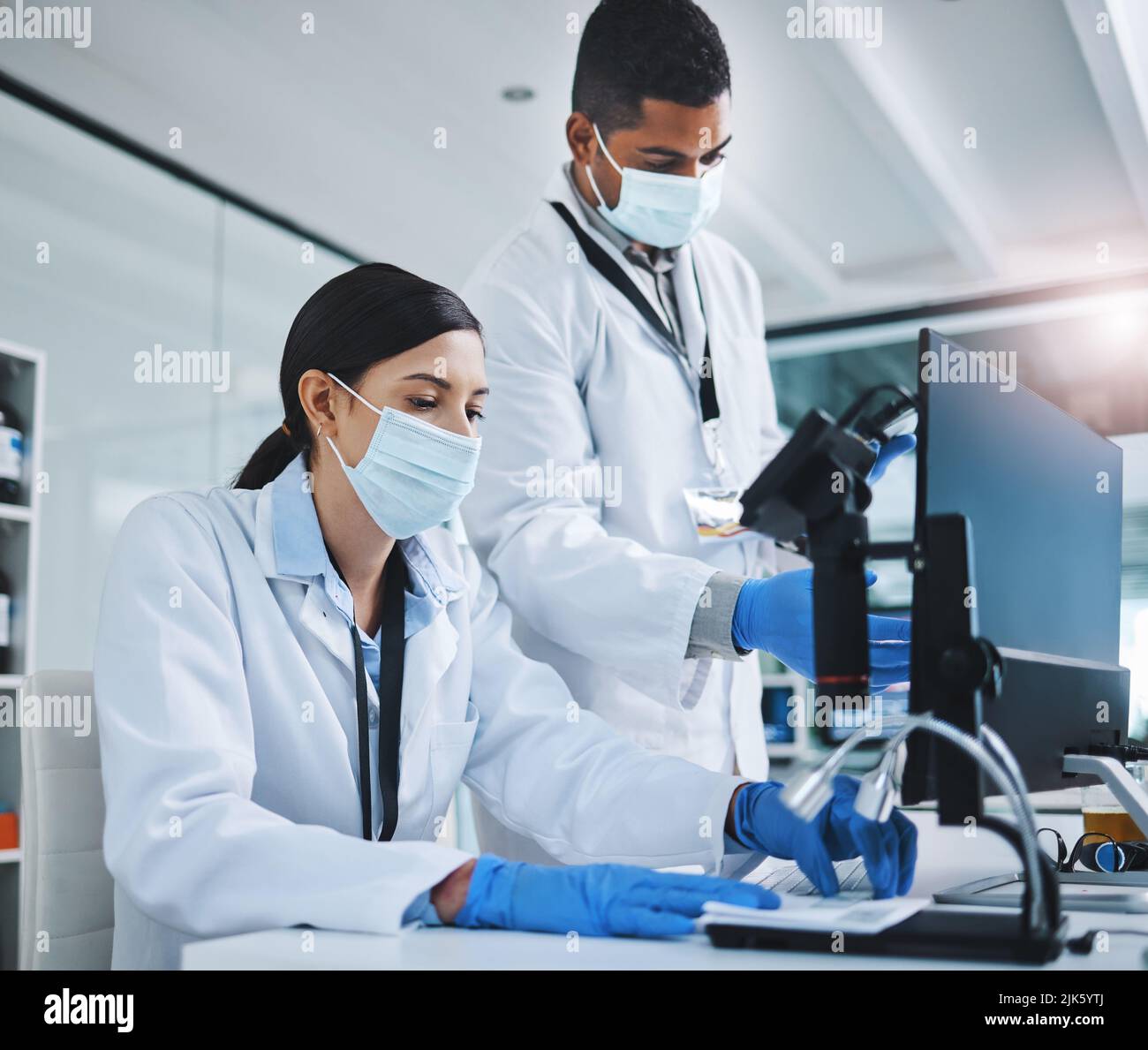 Working hard to get the result we want. two young researchers using a ...