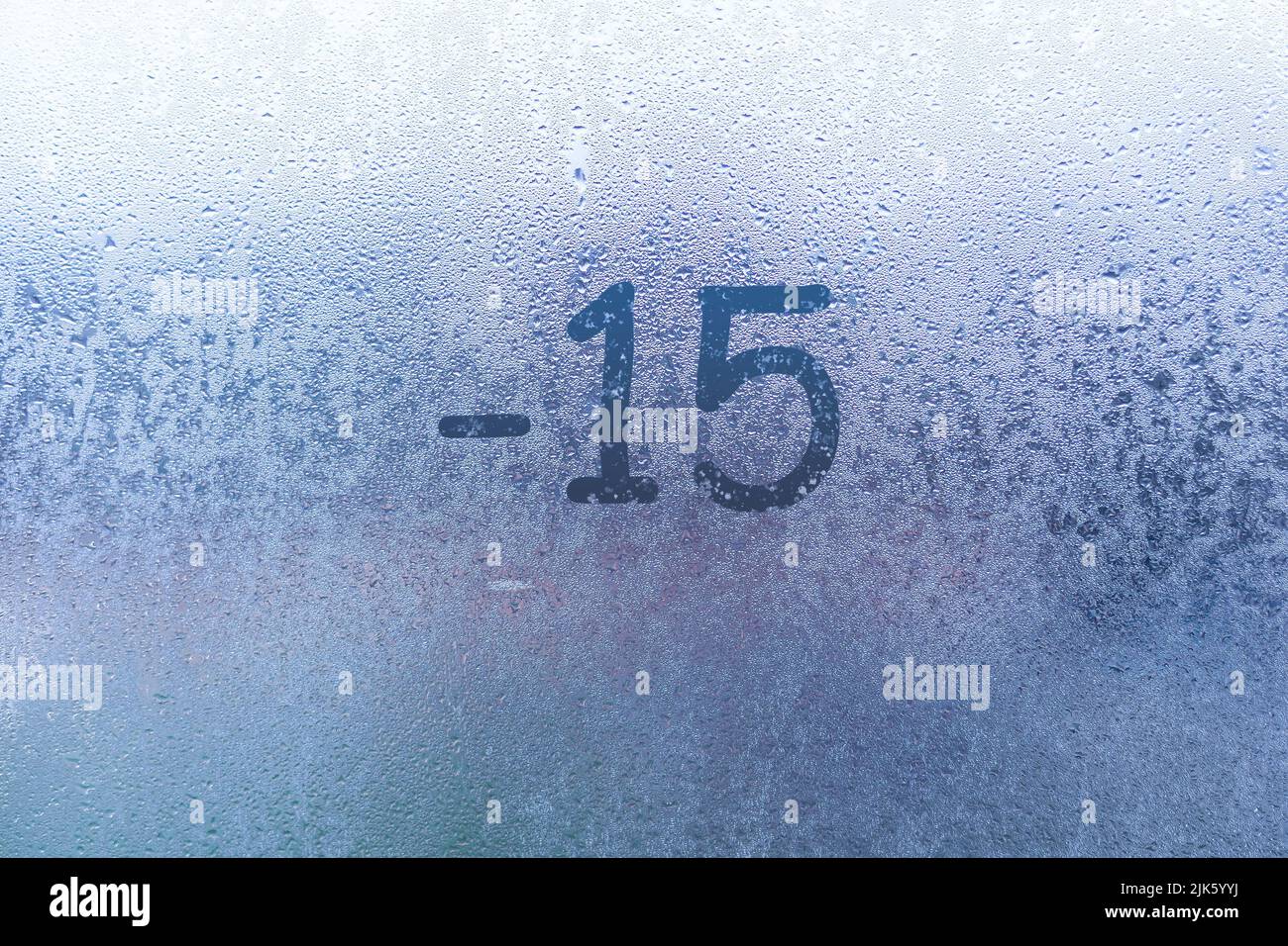 Handwritten temperature on a foggy window. 15 degrees below zero. Cold ...