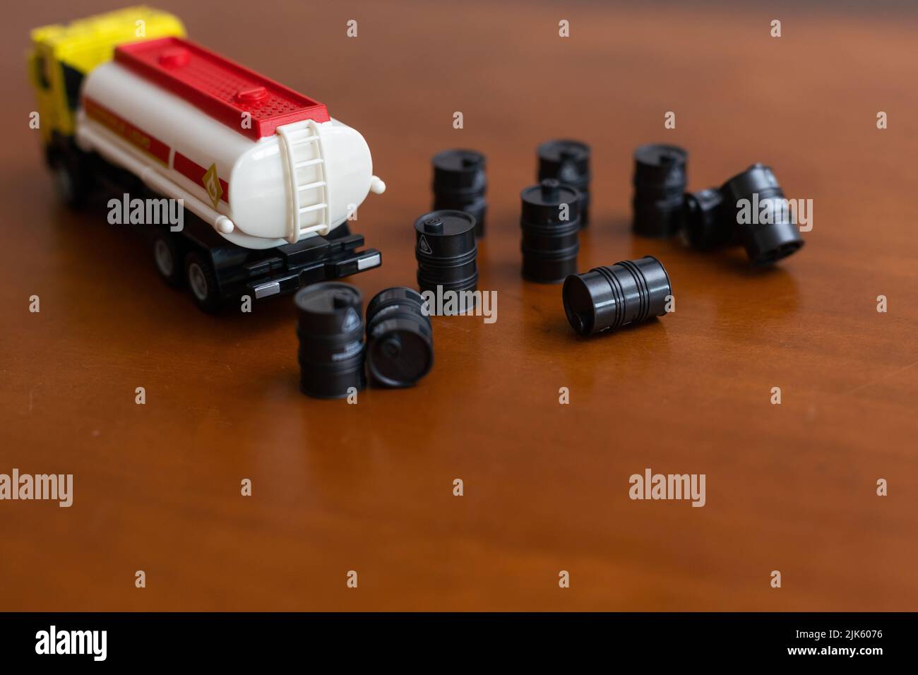 small toy combine with toy oil barrel Stock Photo - Alamy