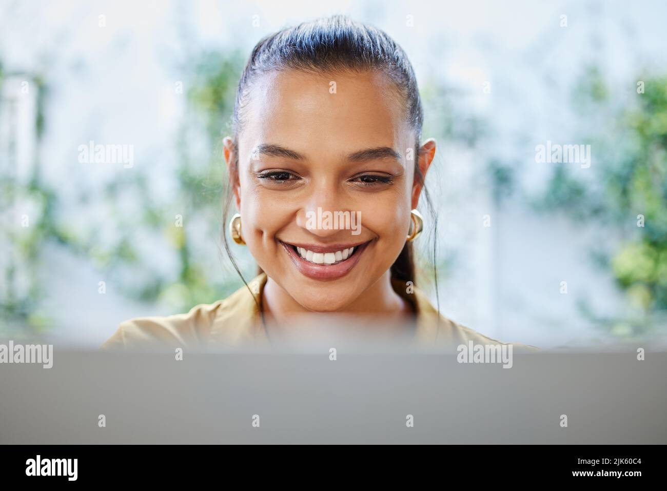 Getting things done from her home office. an attractive young woman ...