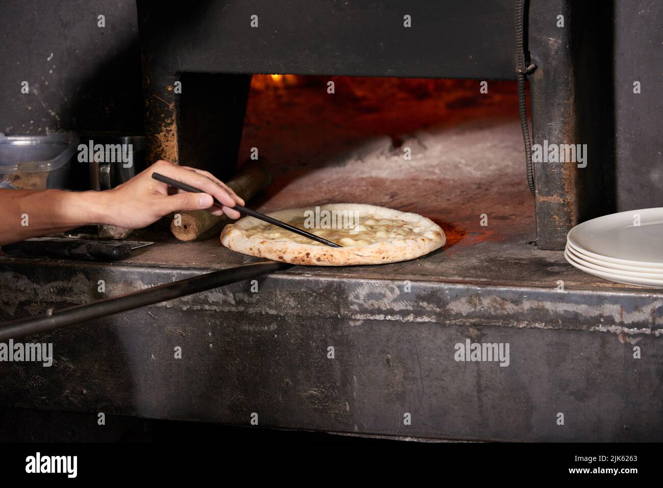 Close-up image of cook baking pizza in oven Stock Photo - Alamy