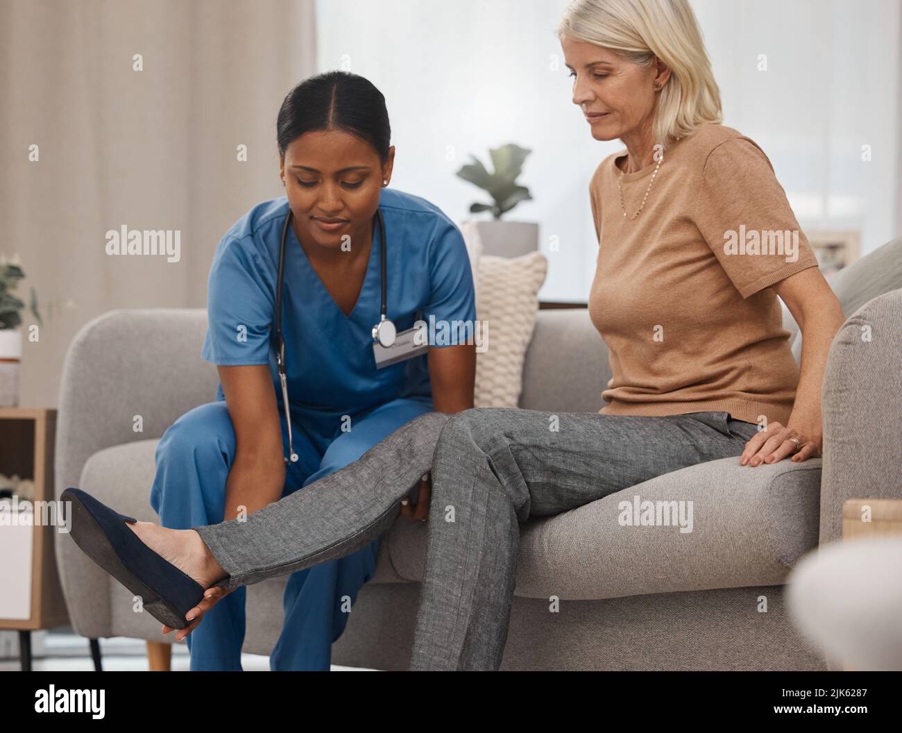 Does the pain feel worse when you flex your ankle. a doctor examining a ...
