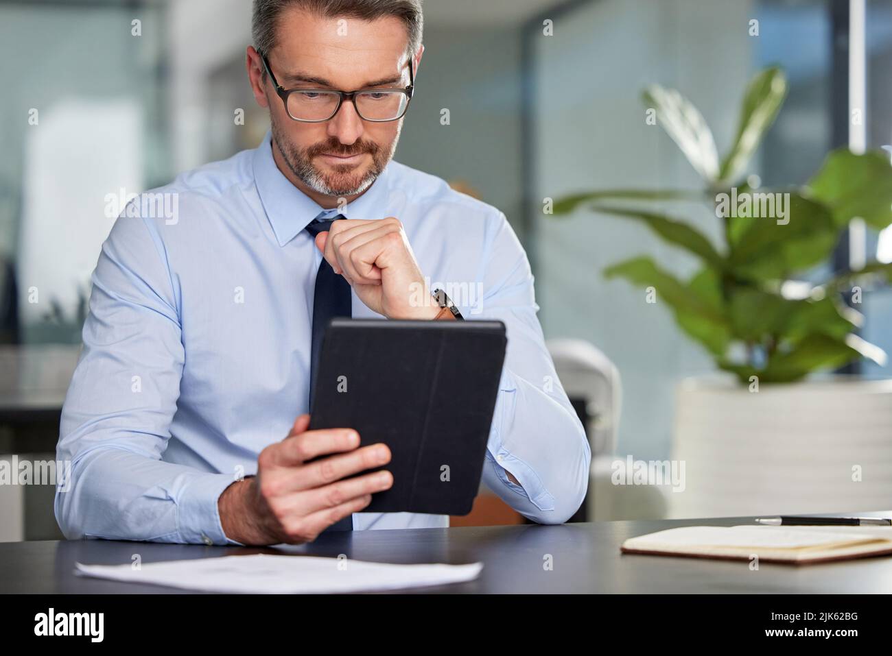 Farewell to the fairground. a mature man using his digital tablet at ...