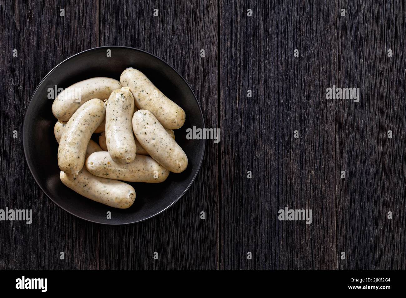Weisswurst in black bowl, white sausages of minced veal, pork back ...