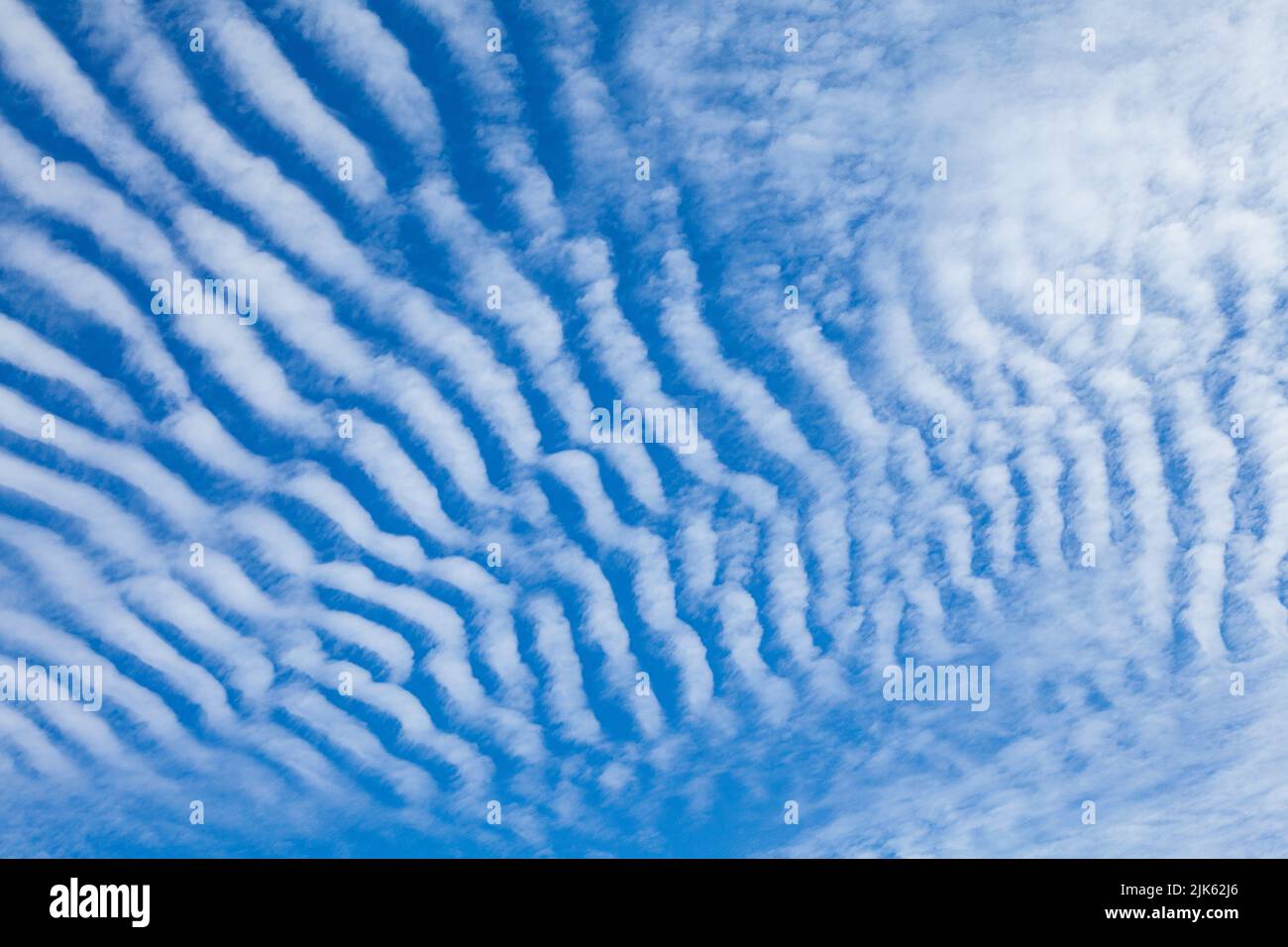 Lines of clouds in the shape of lines arranged parallel to each other ...