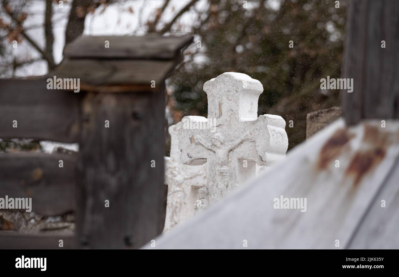Old rural cemetery in winter. Neglected graves with snow in the old ...