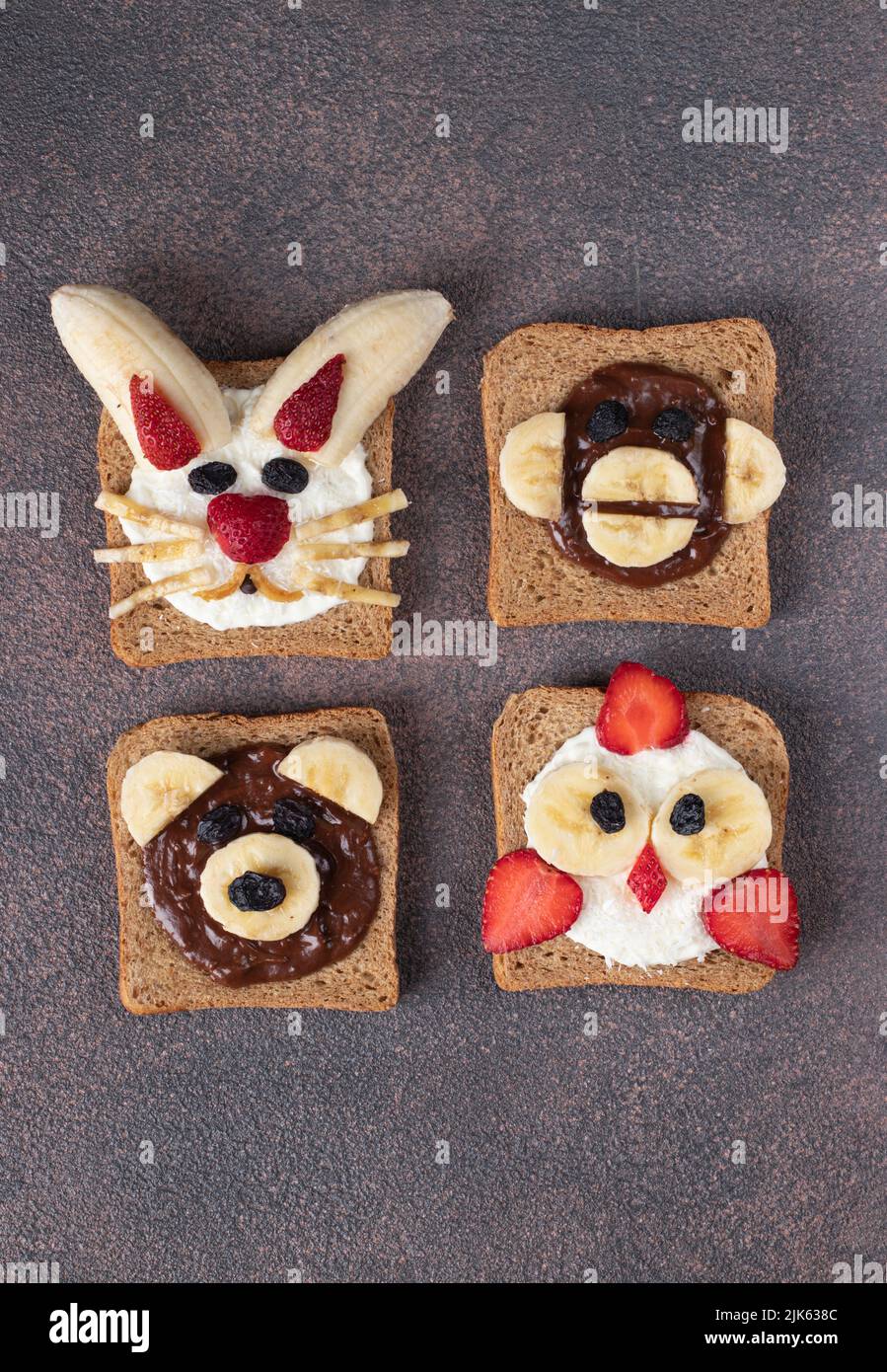 Four sweet toasts for kids in shape of chick, bear, rabbit and monkey ...