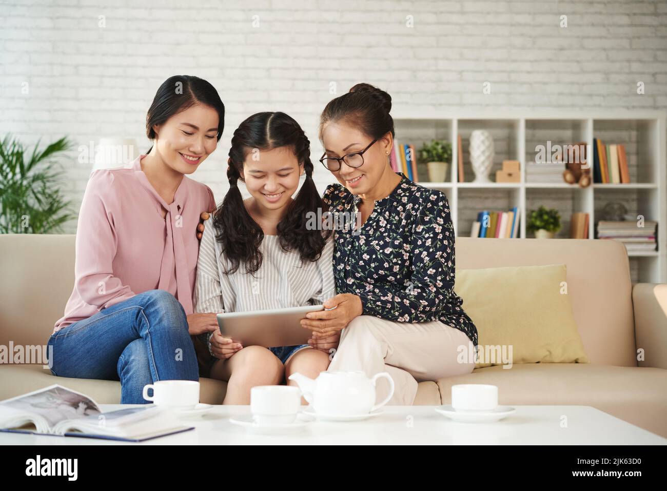 Female generation of family watching videos on tablet computer Stock ...