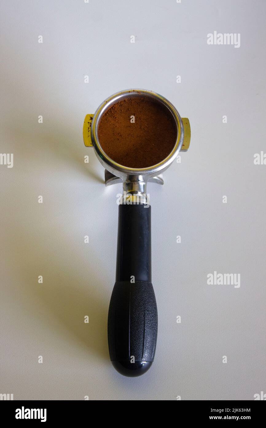 porta filter with ground coffee and coffee bean isolated from a white ...