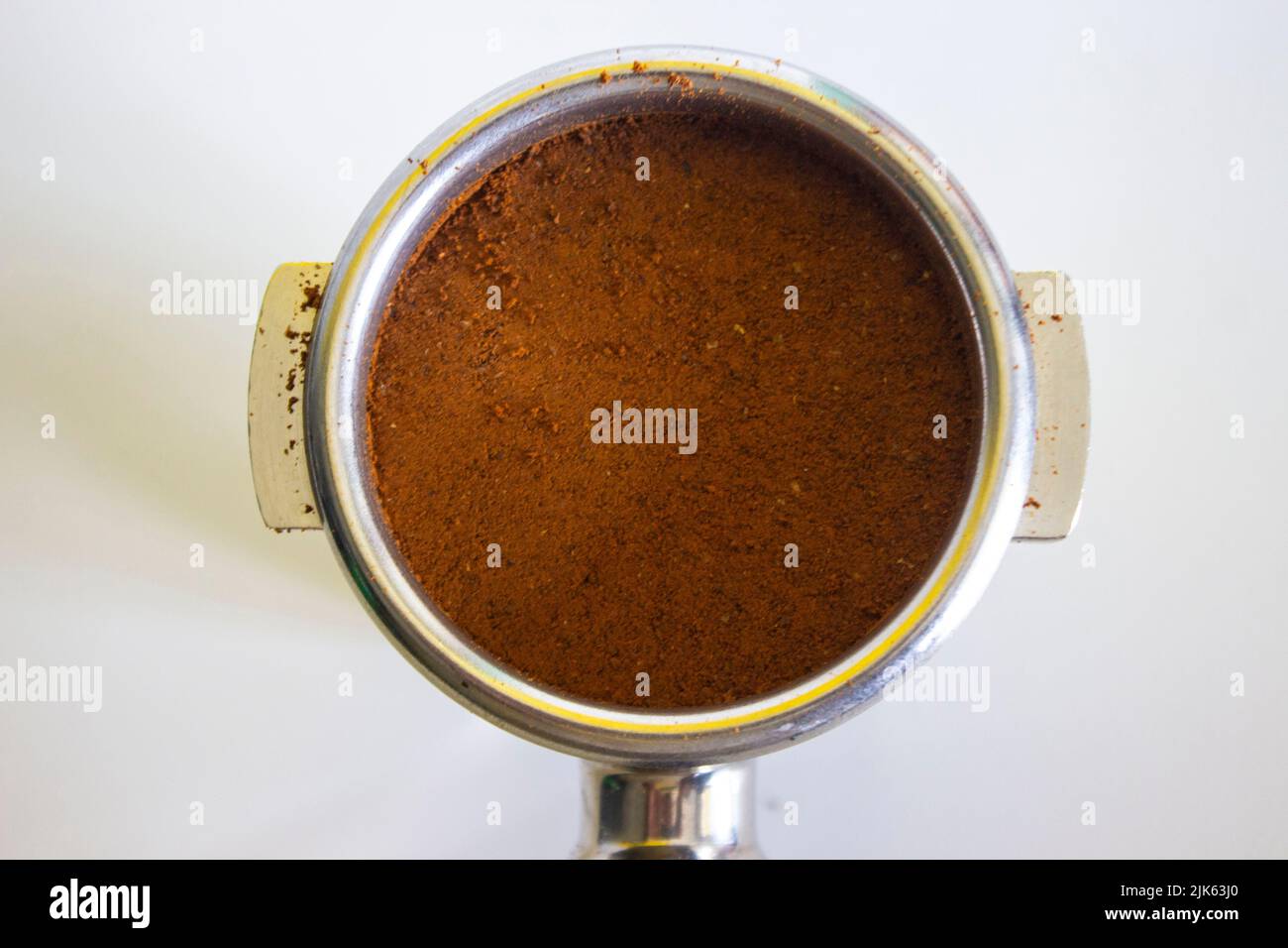 porta filter with ground coffee and coffee bean isolated from a white ...