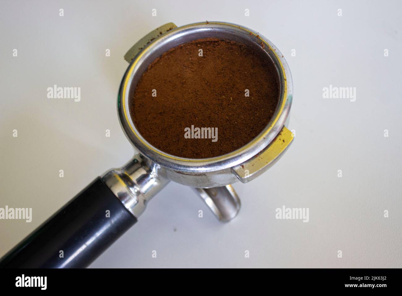porta filter with ground coffee and coffee bean isolated from a white ...