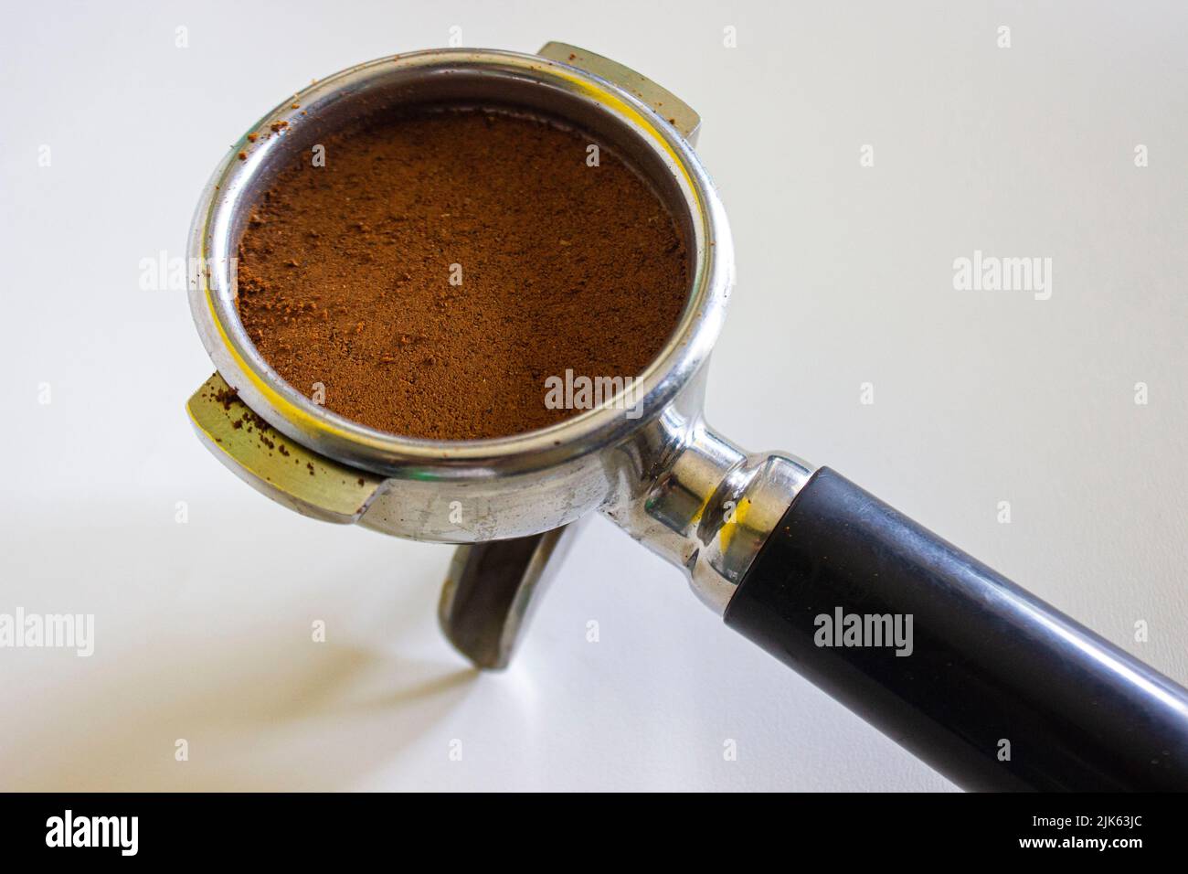 porta filter with ground coffee and coffee bean isolated from a white ...