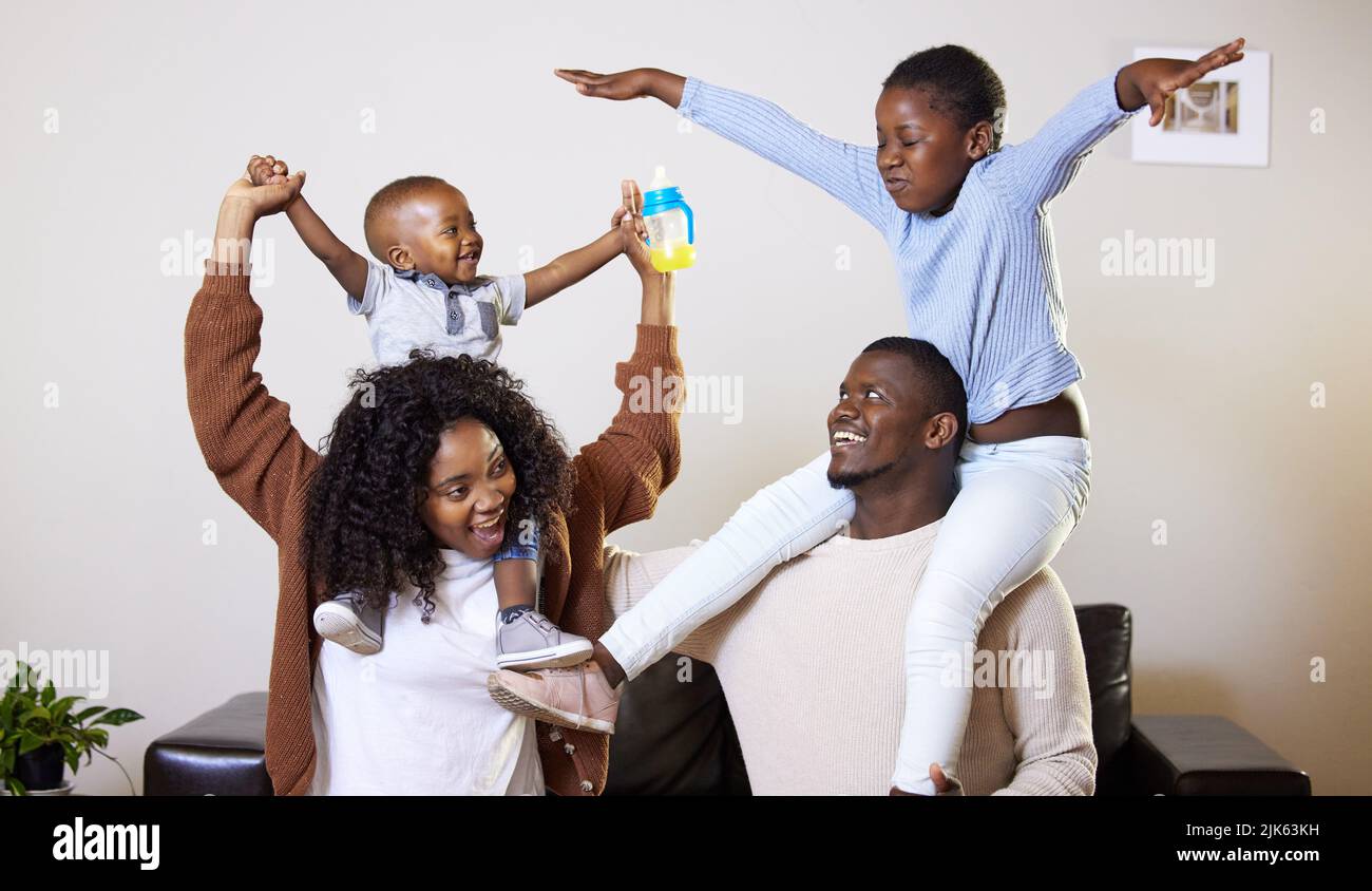 They keep us on our toes. two young parents bonding and playing with ...