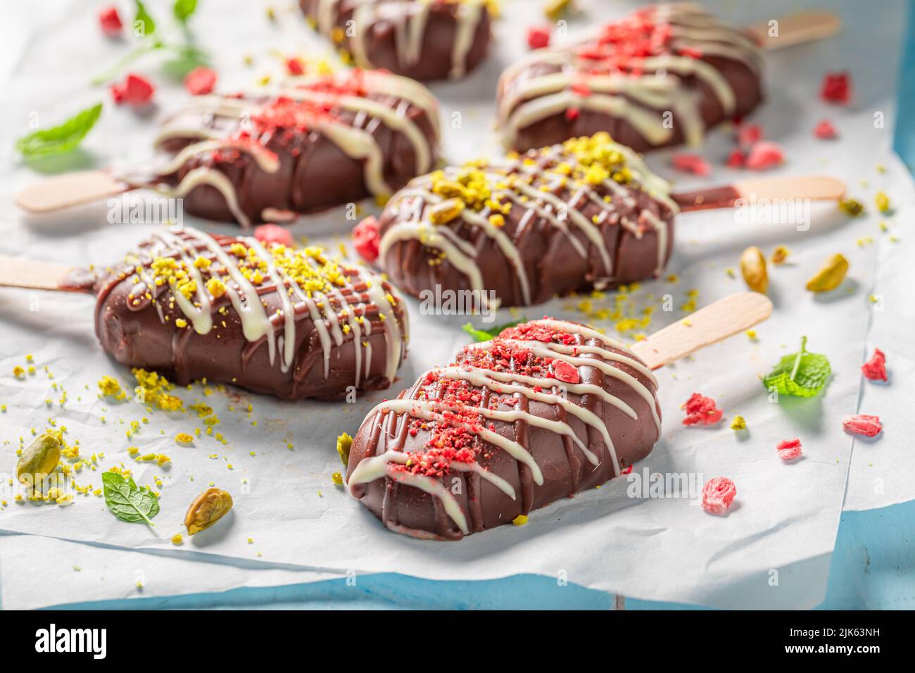 Delicious and homemade popsicles with chocolate topping and pistachios ...