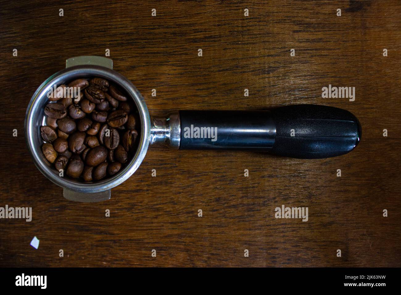 porta filter with ground coffee and coffee bean on table Stock Photo ...