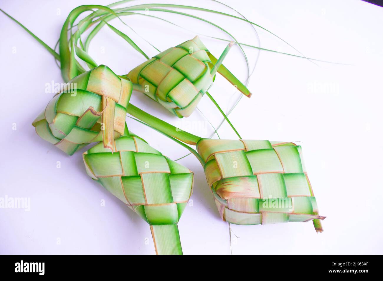 ketupat in earthenware plate isolated on white background. Ketupat ...