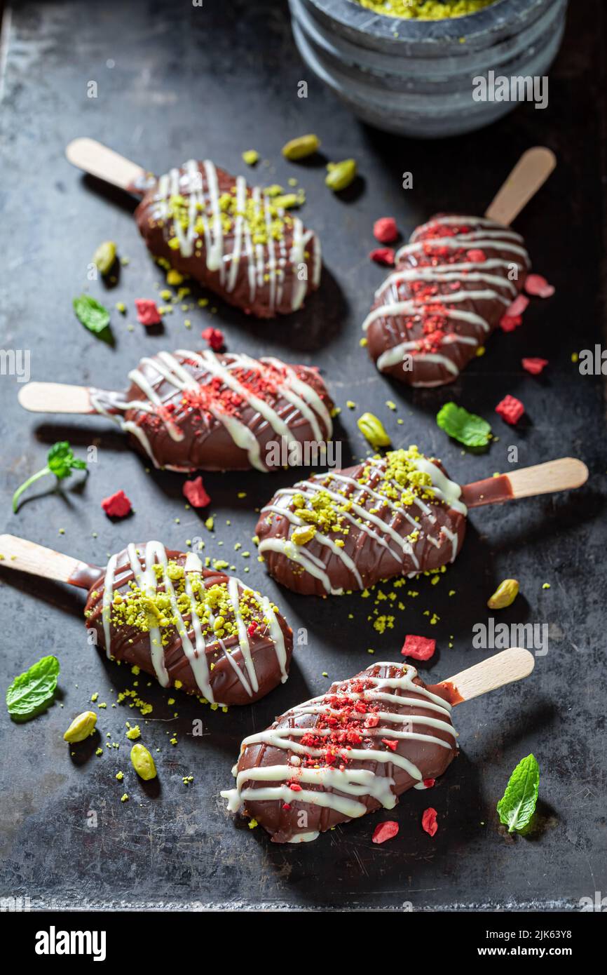 Sweet and chocolate popsicles with fruits and chocolate topping ...