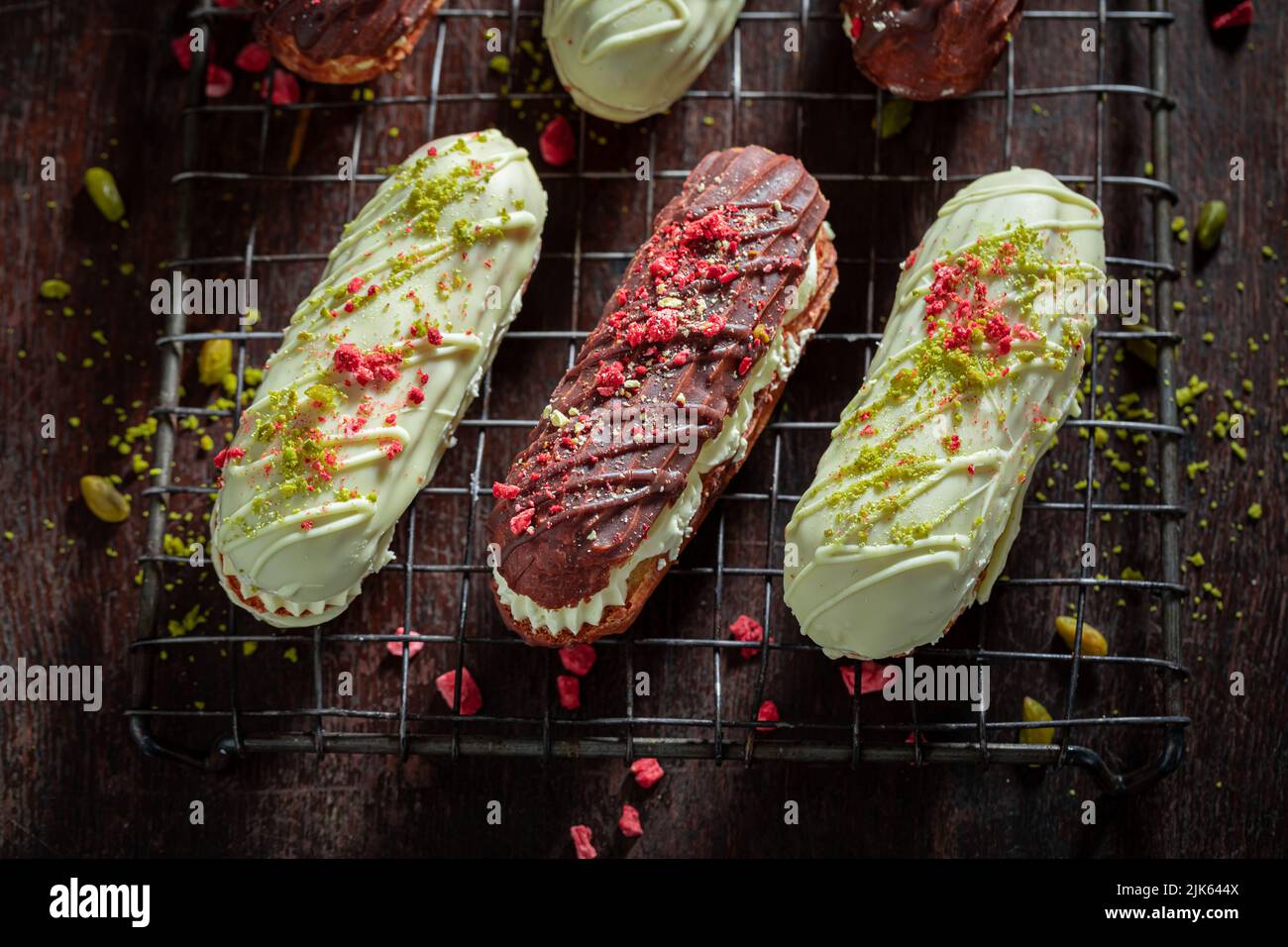 Delicious and homemade eclairs with chocolate topping and pistachios ...