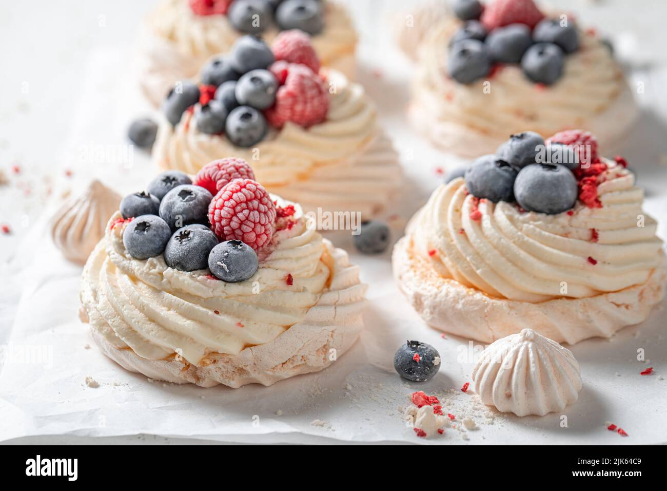 Homemade and tasty Pavlova dessert with fruits and white meringue. Mini ...